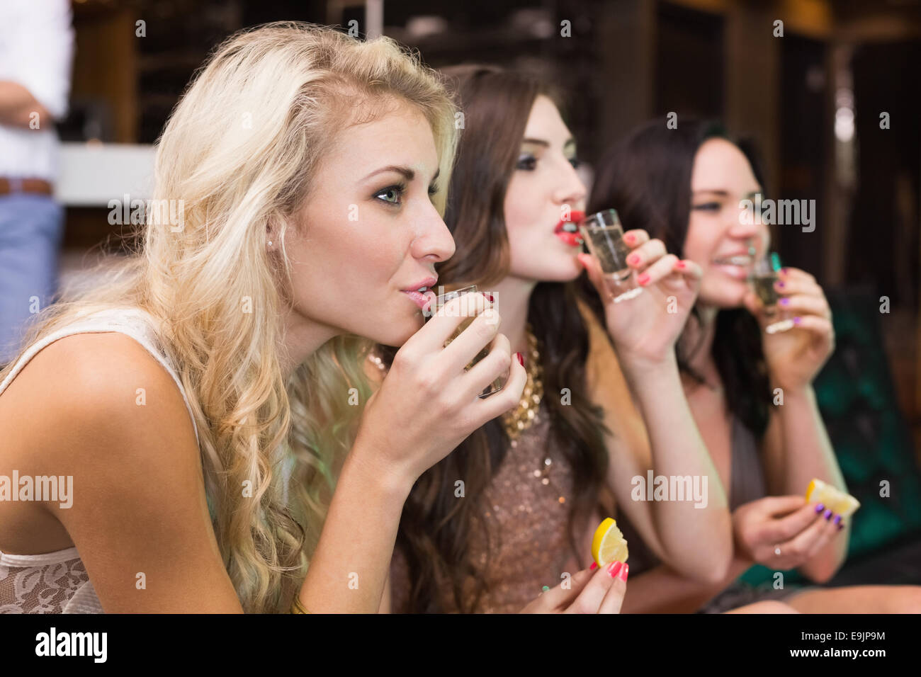 Happy friends drinking shots together Stock Photo - Alamy