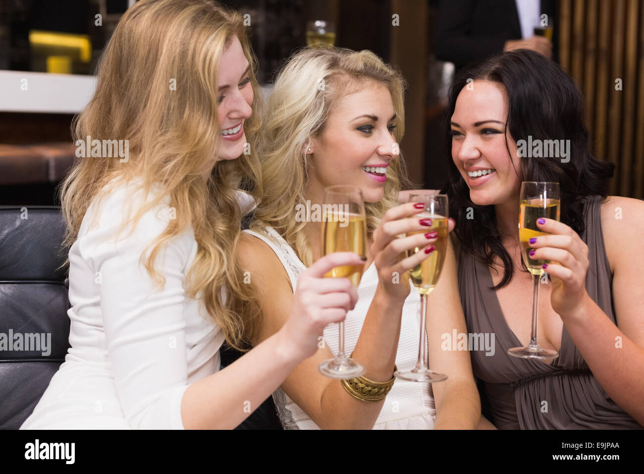 Happy friends drinking champagne together Stock Photo - Alamy