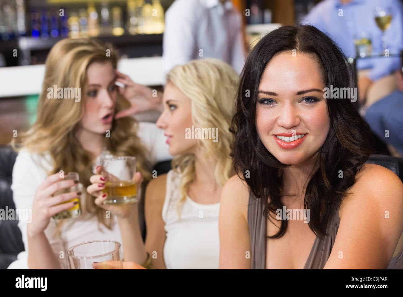 Pretty friends having a drink together Stock Photo - Alamy