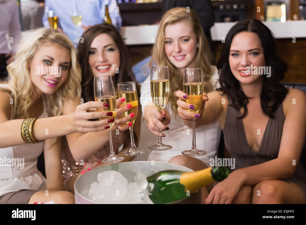 Pretty friends drinking champagne together Stock Photo - Alamy
