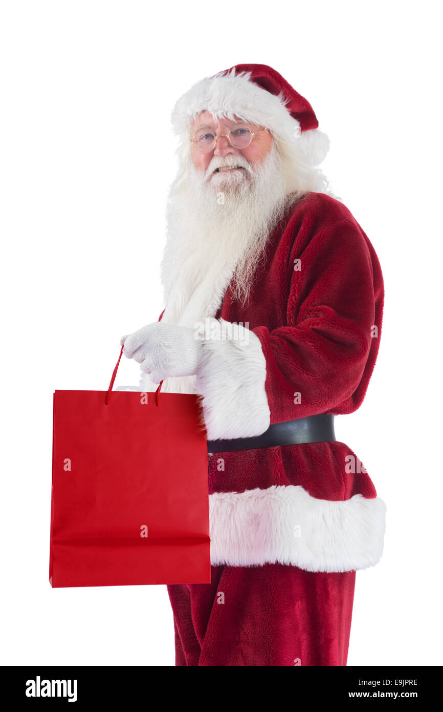 Santa carries red gift bag Stock Photo - Alamy