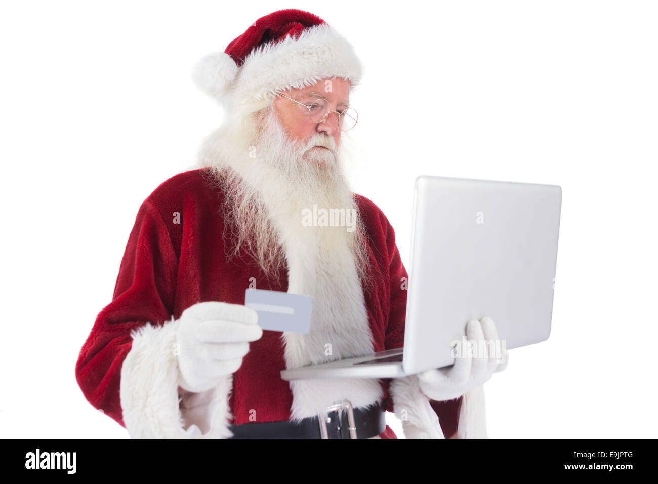 Santa pays with credit card on a laptop Stock Photo - Alamy