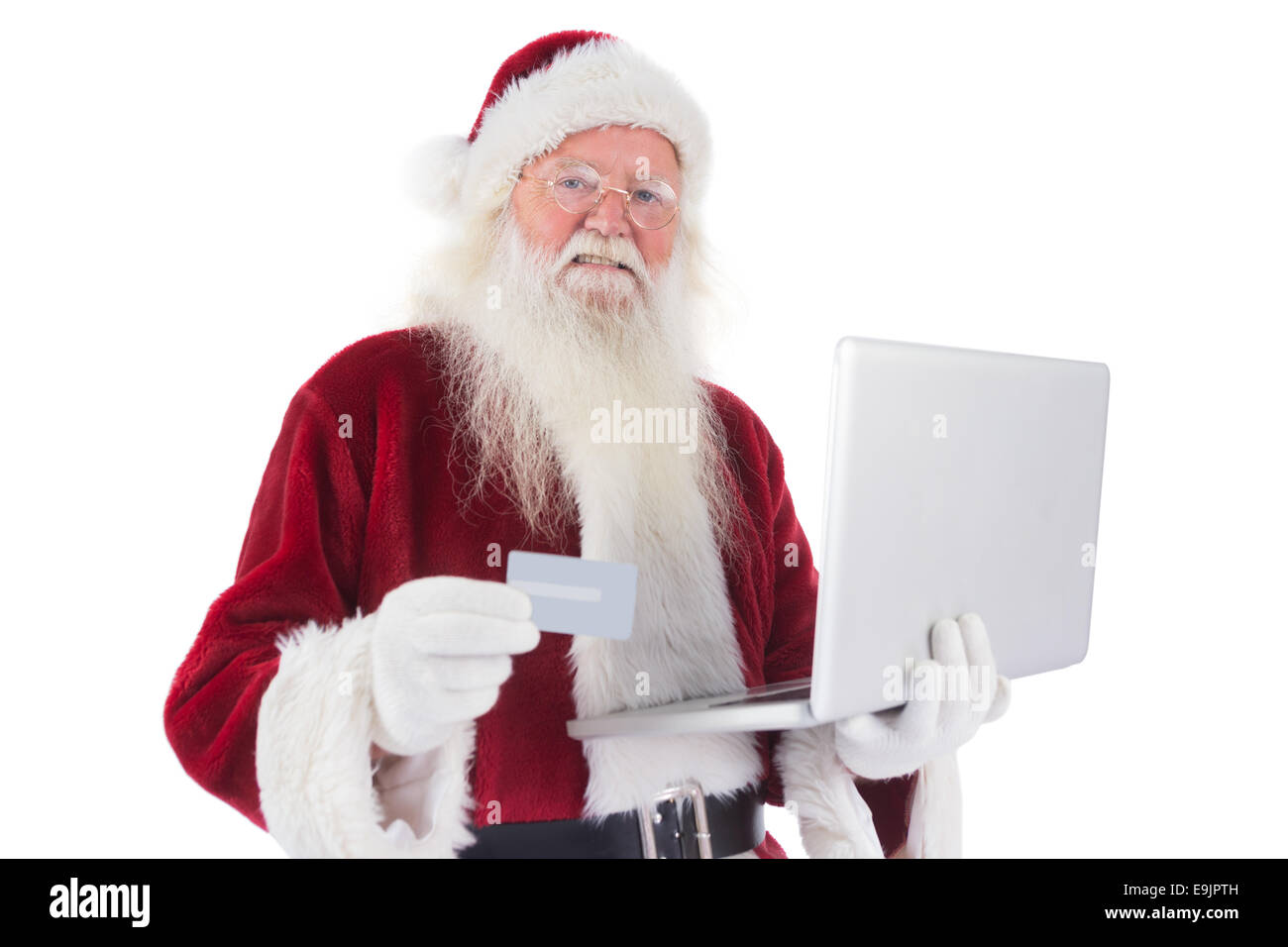 Santa pays with credit card on a laptop Stock Photo - Alamy