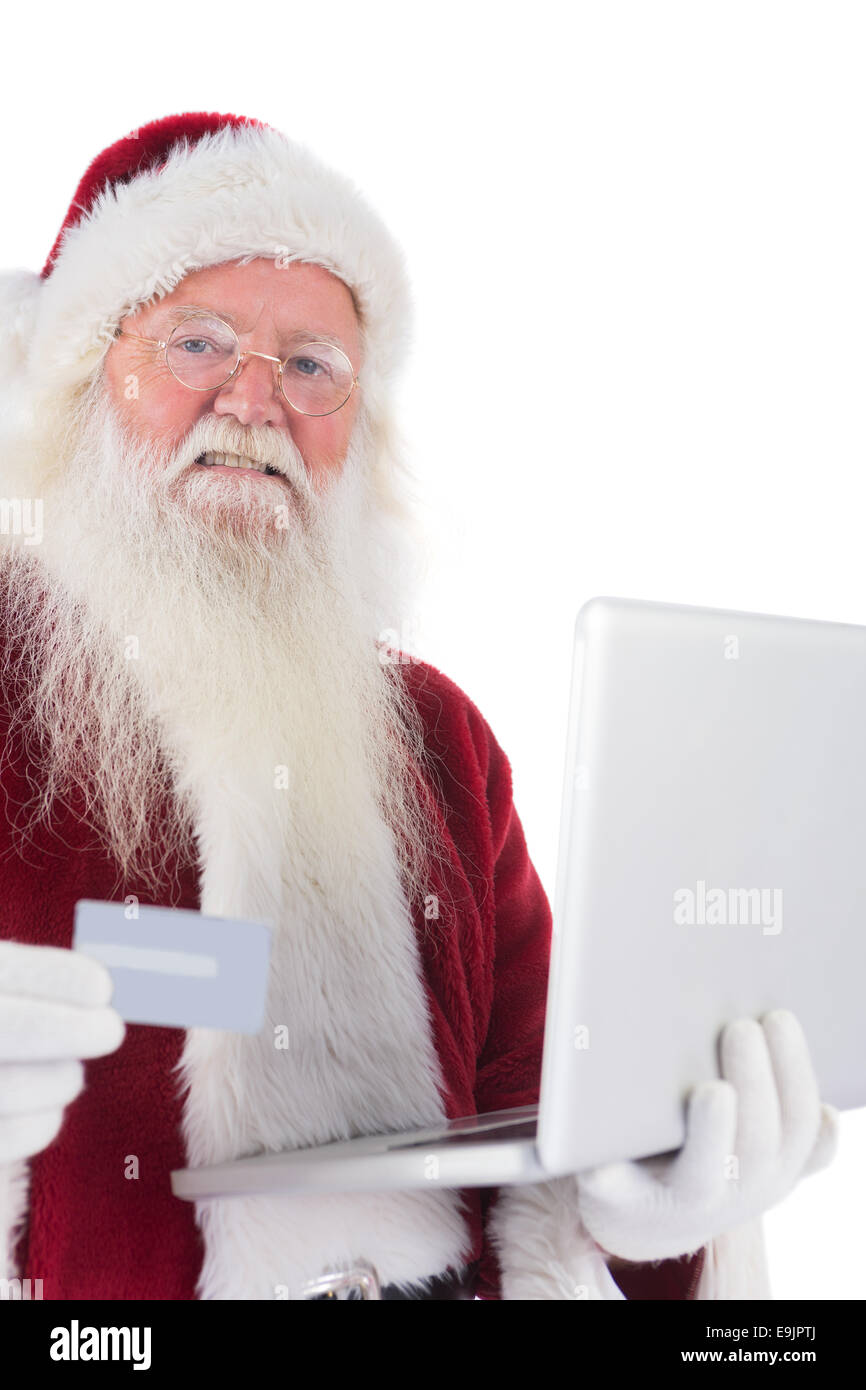 Santa pays with credit card on a laptop Stock Photo - Alamy