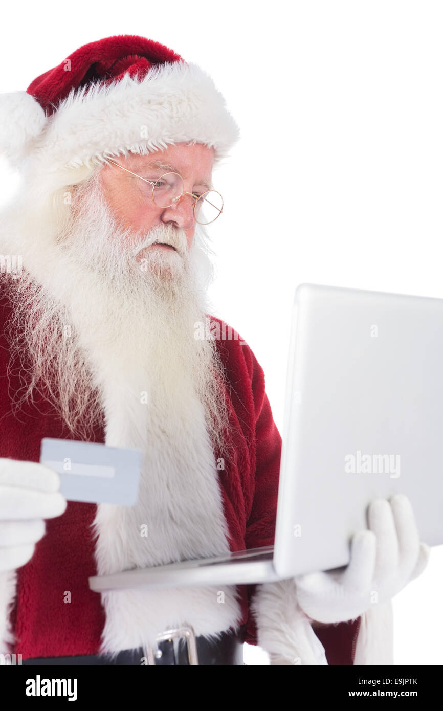 Santa pays with credit card on a laptop Stock Photo - Alamy