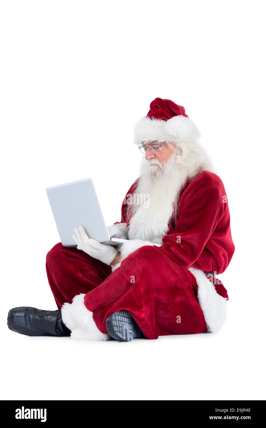 Santa sits and uses a laptop Stock Photo - Alamy