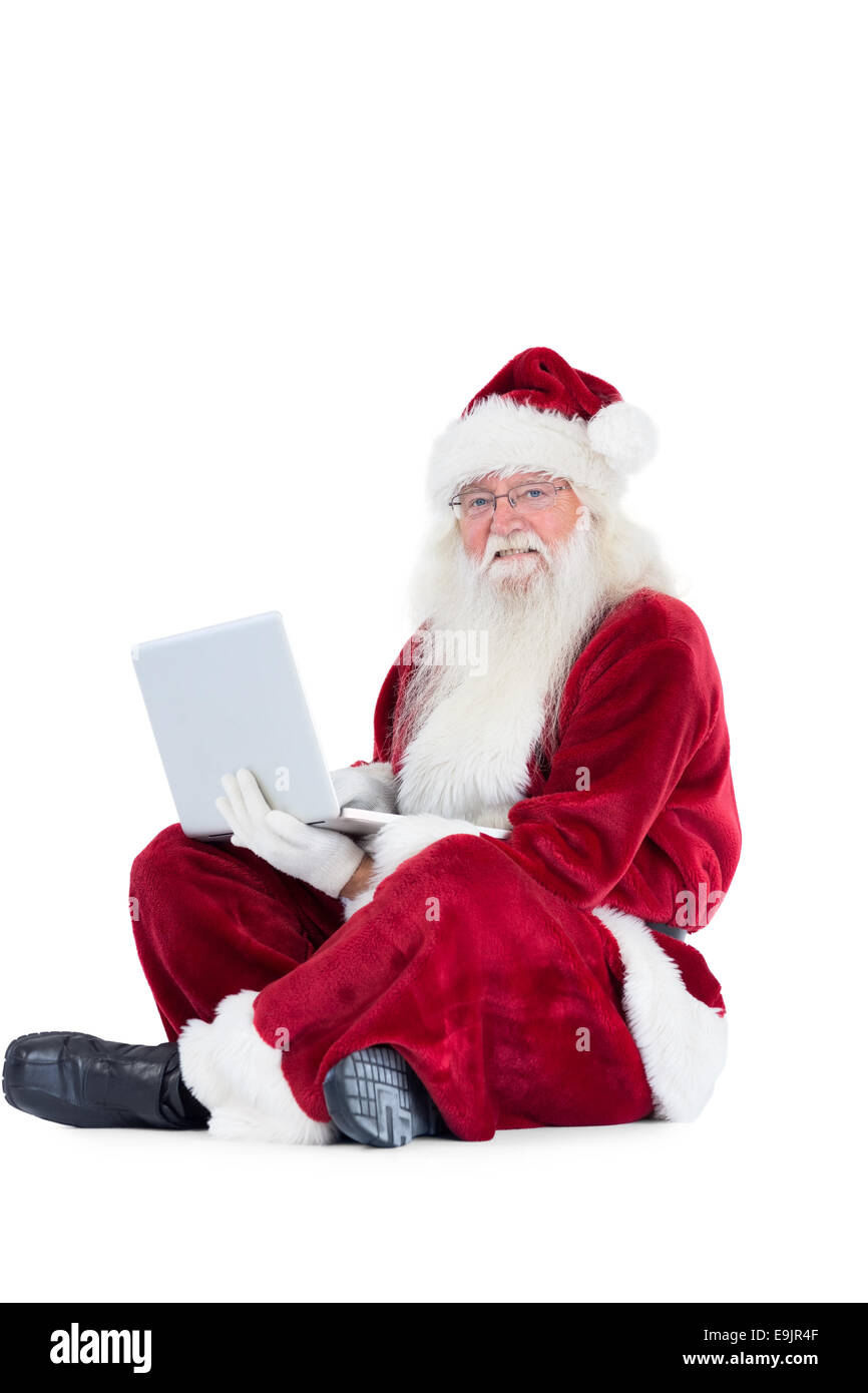 Santa sits and uses a laptop Stock Photo - Alamy