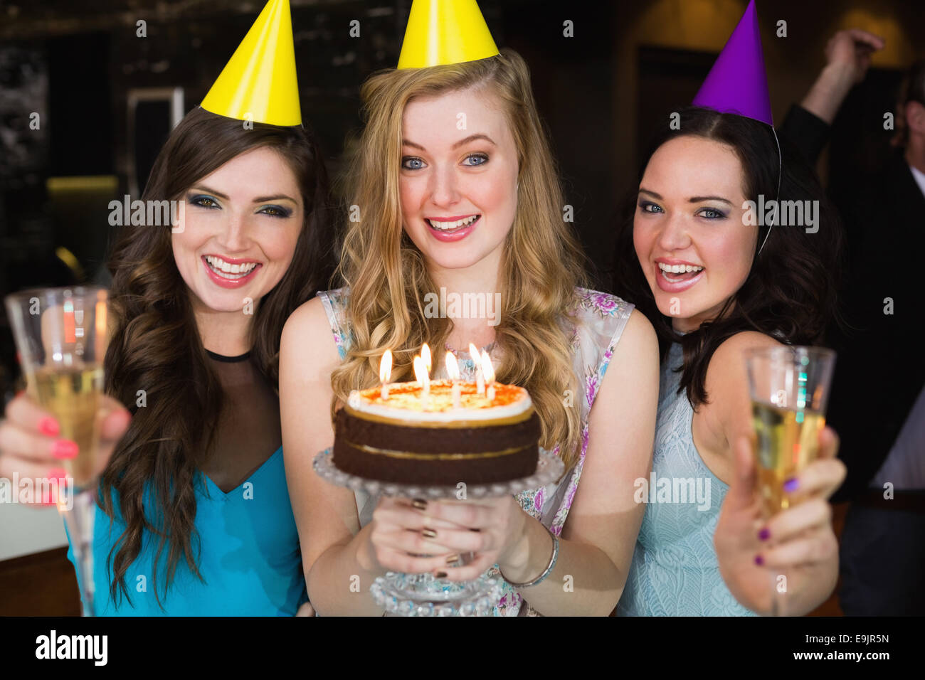 Attractive friends celebrating a birthday Stock Photo - Alamy