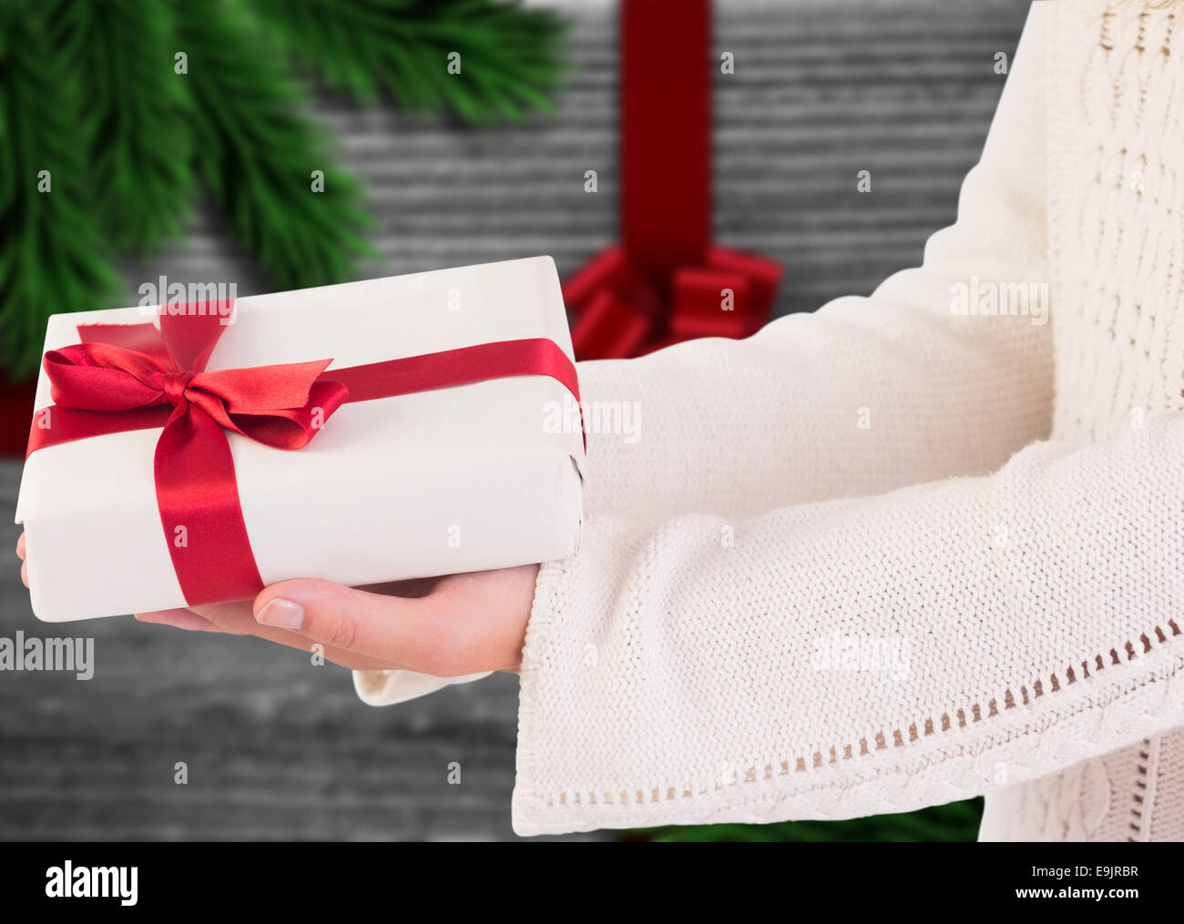 Composite image of woman offering a gift box Stock Photo - Alamy
