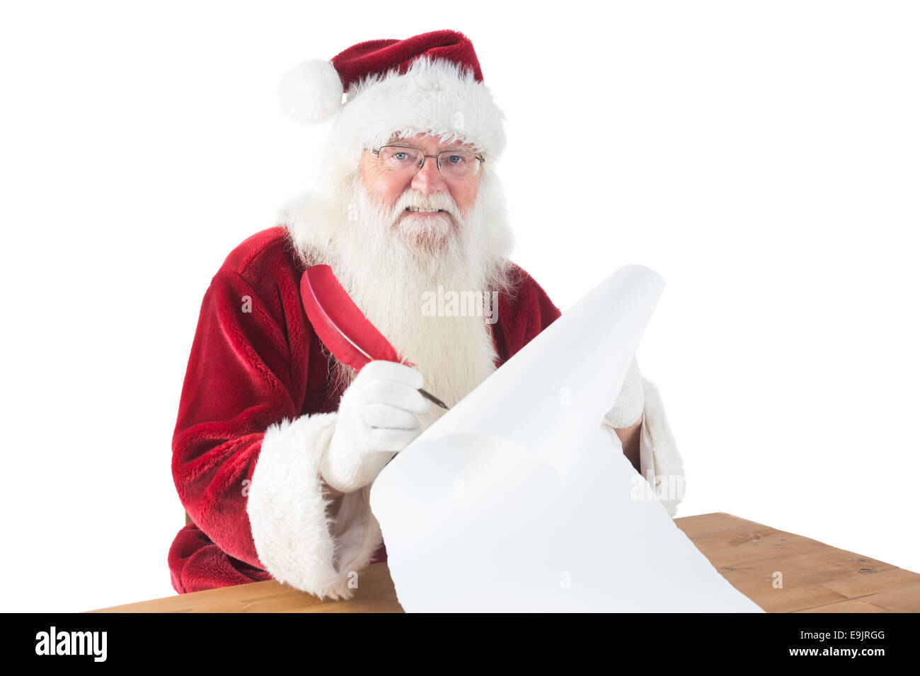 Santa writes something with a feather Stock Photo - Alamy