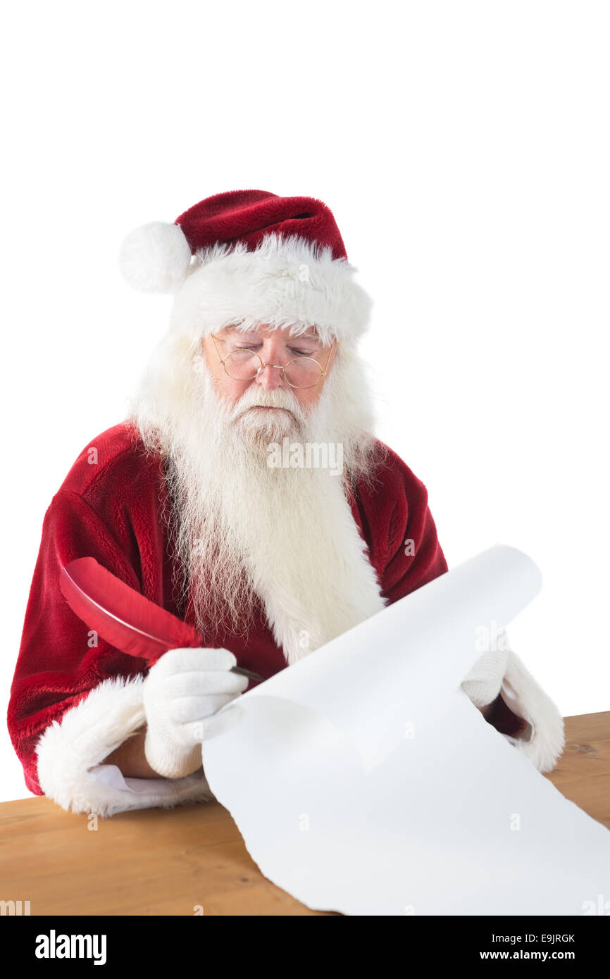 Santa writes something with a feather Stock Photo - Alamy