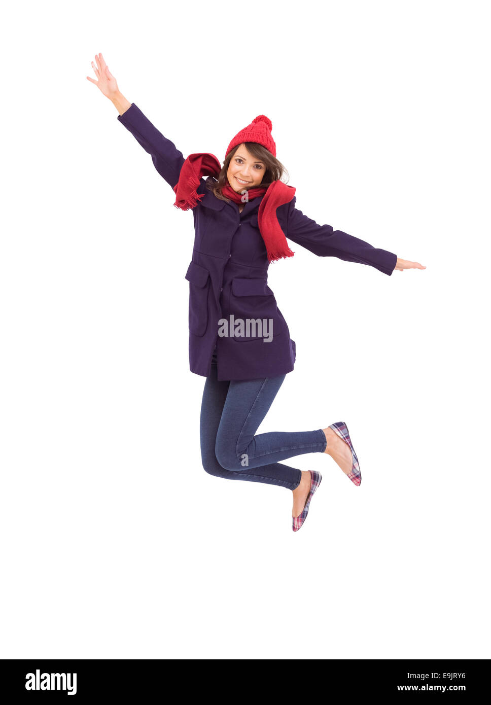 Woman in warm clothing jumping Stock Photo - Alamy
