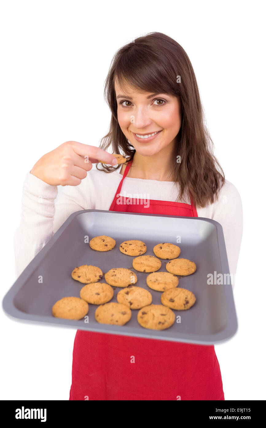 Festive brunette showing hot cookies Stock Photo - Alamy