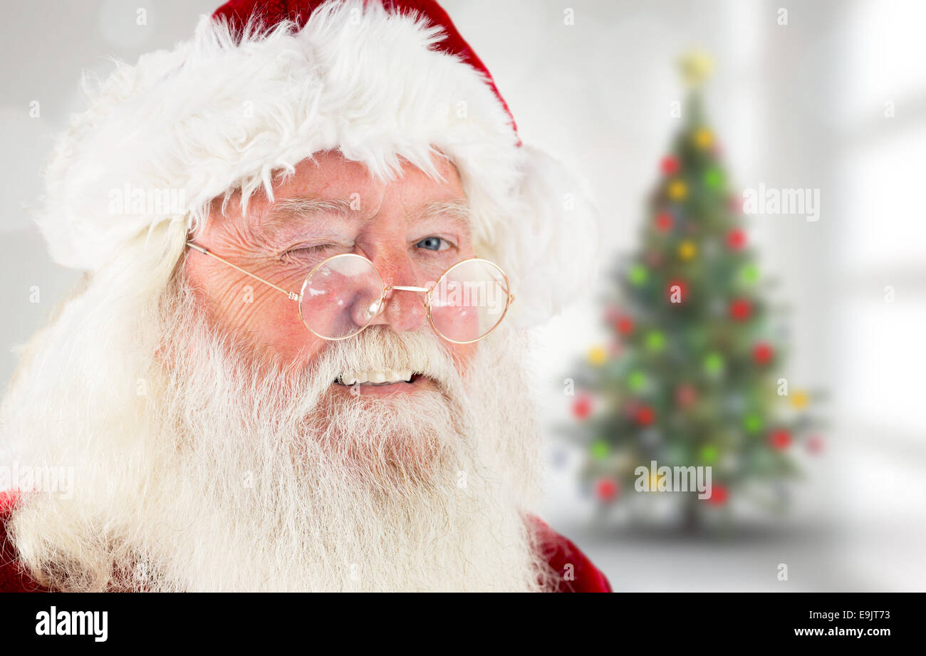 Composite image of santa claus winking Stock Photo - Alamy