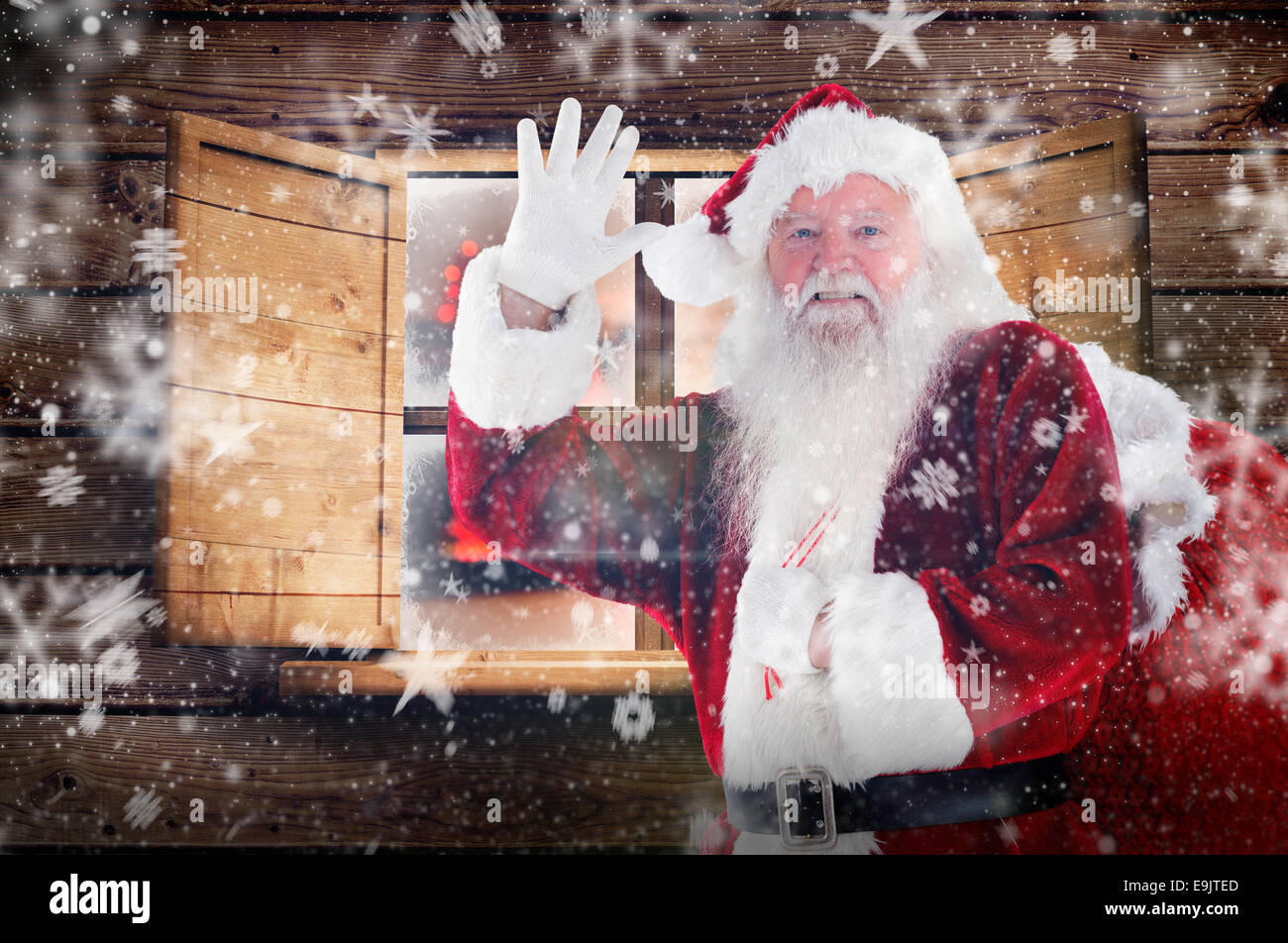 Composite image of santa claus waving Stock Photo - Alamy