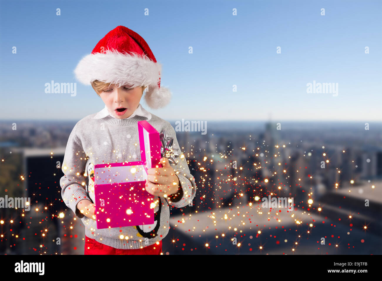 Composite image of festive boy holding a gift Stock Photo - Alamy