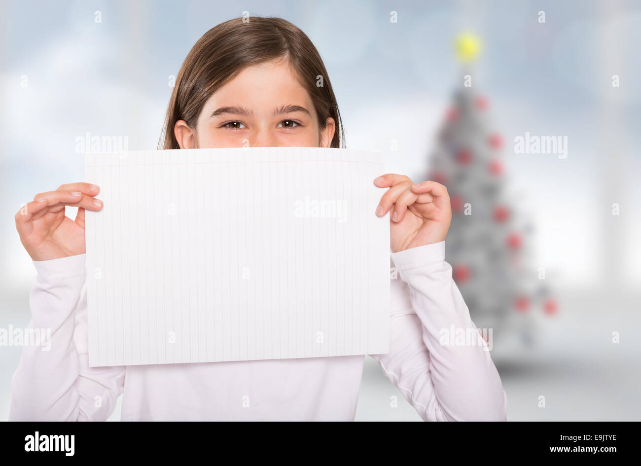 Composite image of cute little girl showing card Stock Photo - Alamy