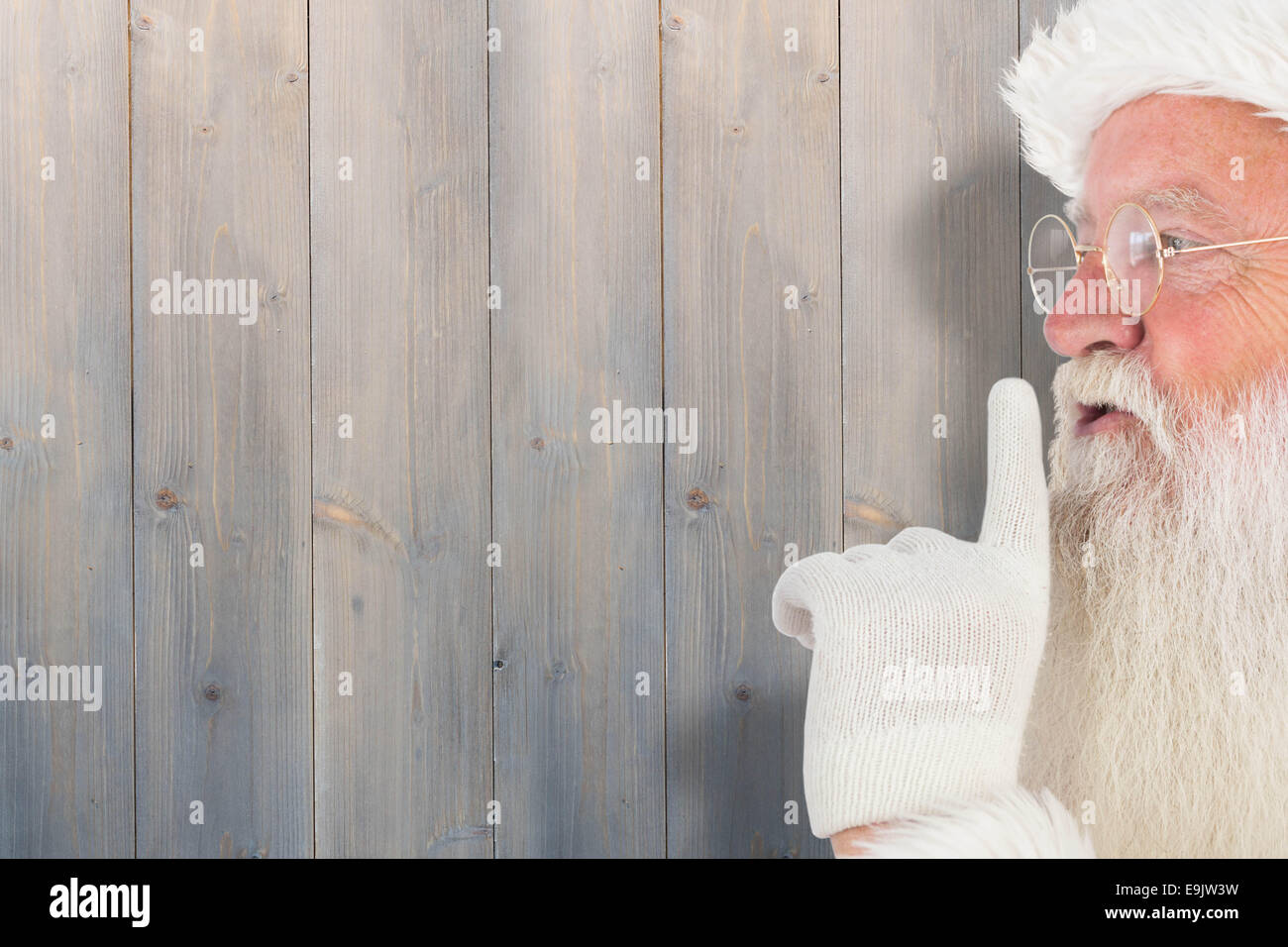 Composite image of santa claus making quiet sign Stock Photo - Alamy