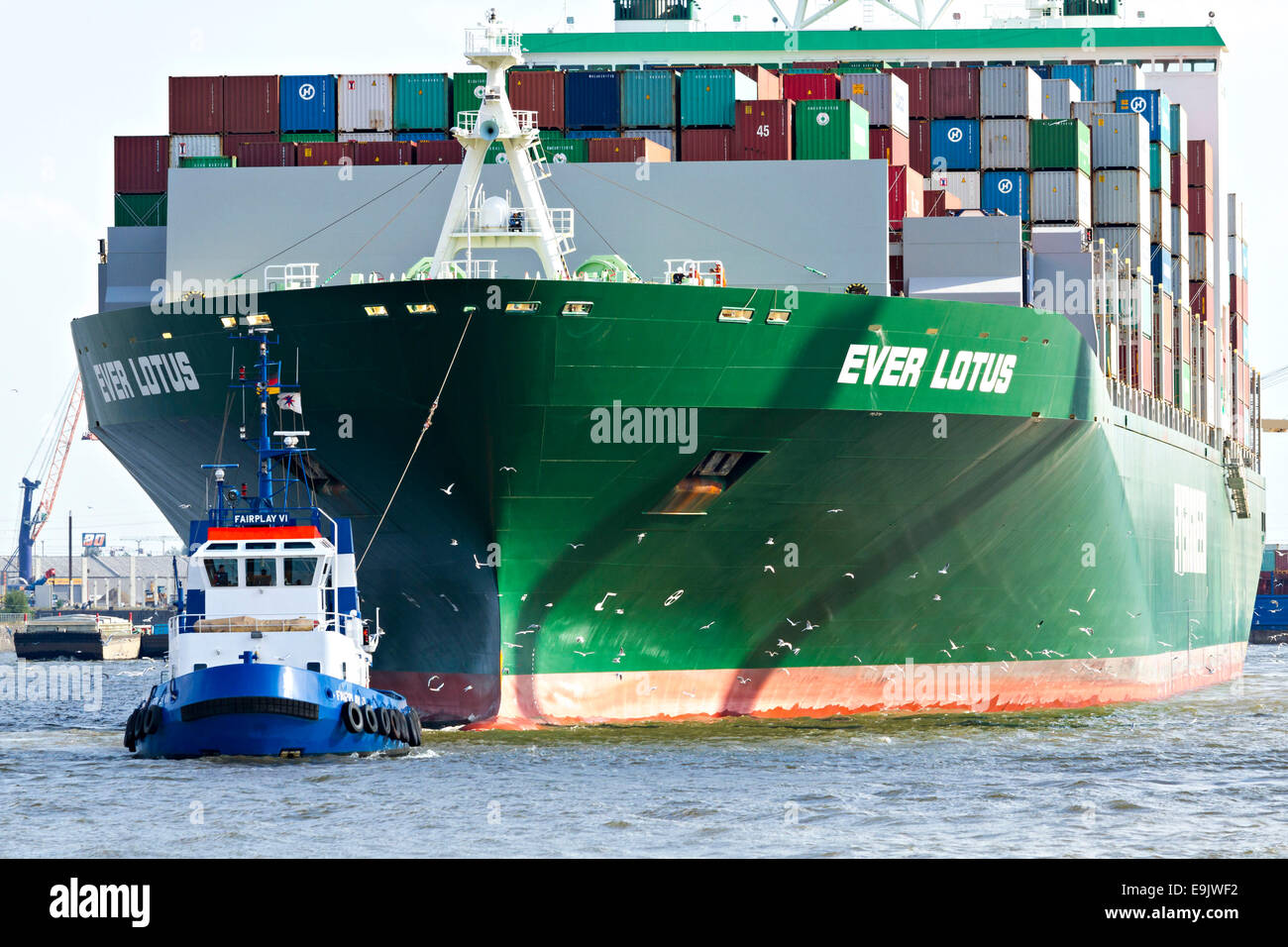 Container Ship Ever Lotus being towed by tug boat, Hamburg Harbour ...