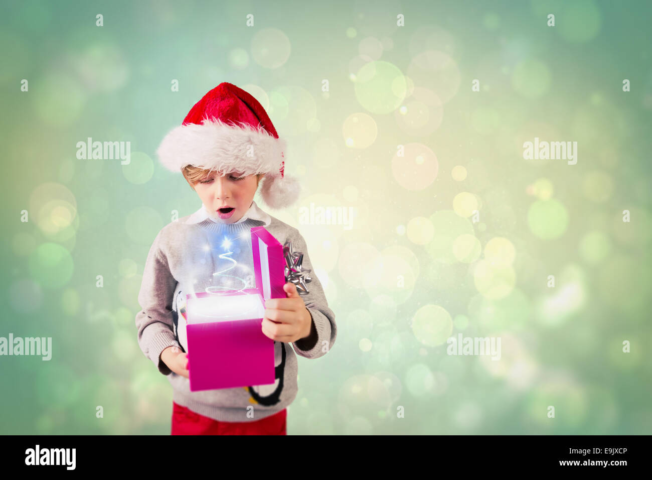 Composite image of festive boy holding a gift Stock Photo - Alamy