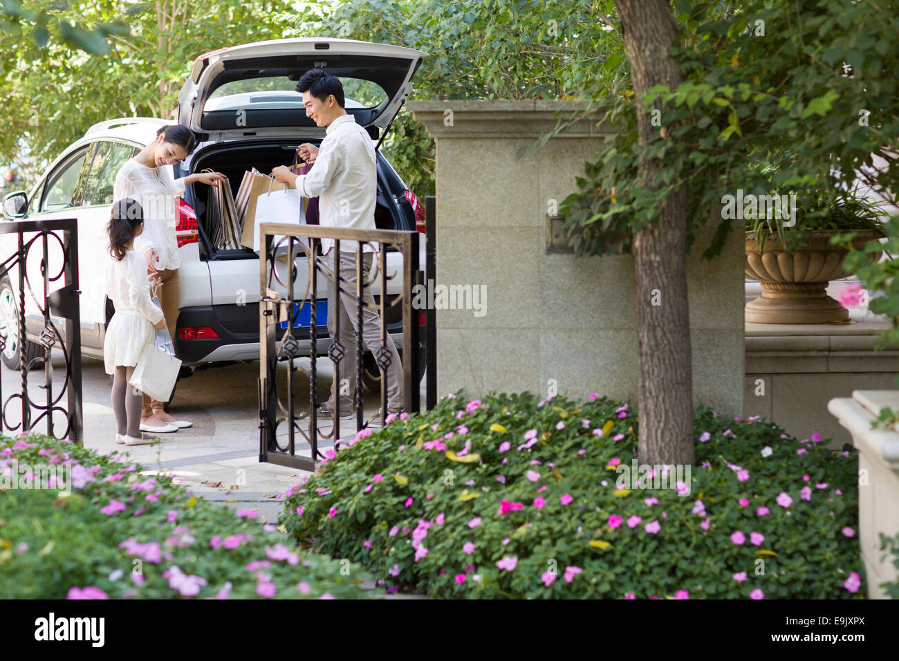 Young family coming back from shopping Stock Photo - Alamy