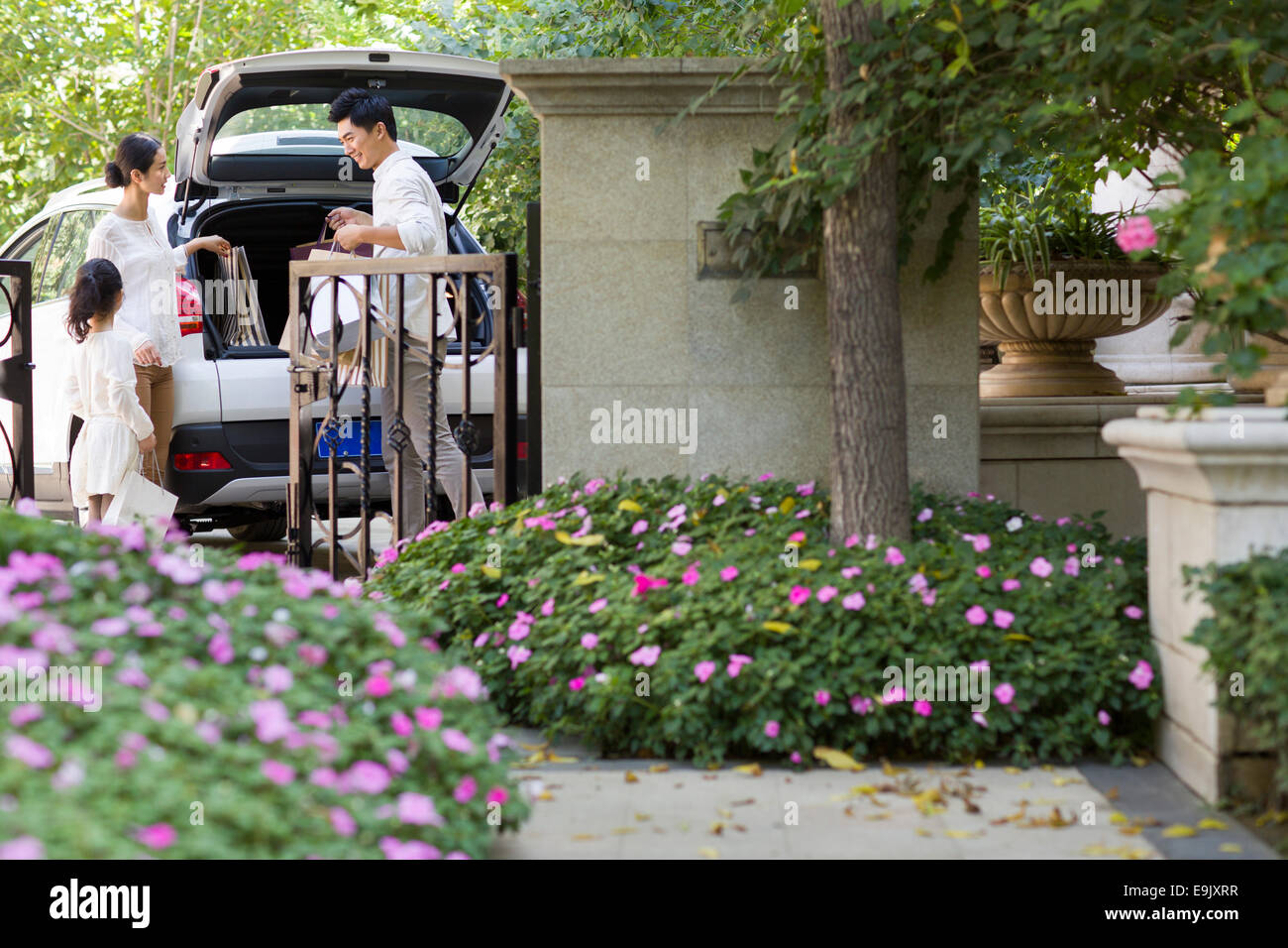 Young family coming back from shopping Stock Photo - Alamy