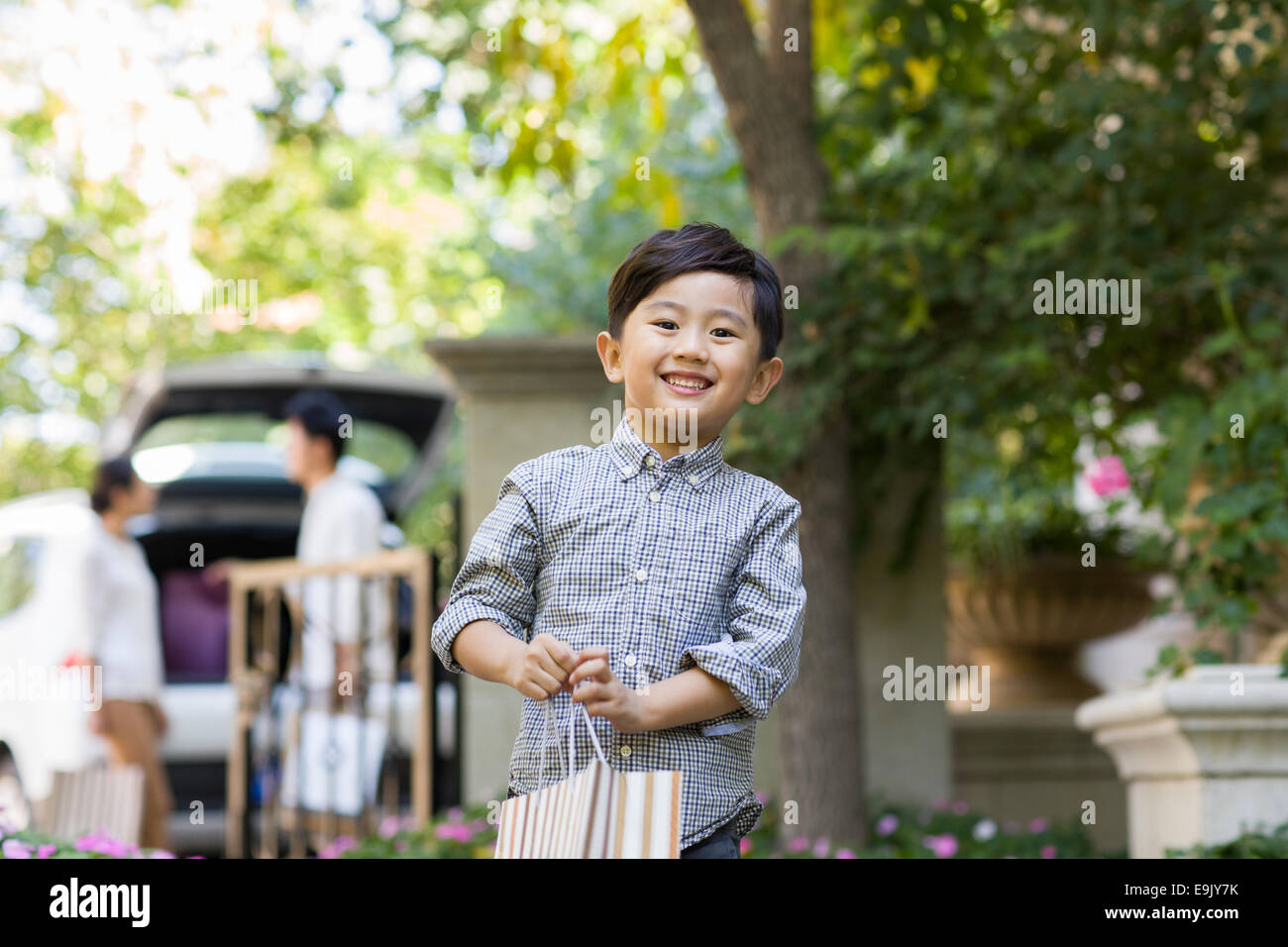 Young family coming back from shopping Stock Photo - Alamy
