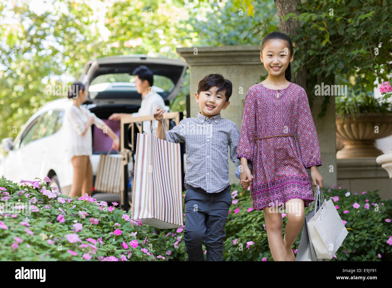 Young family coming back from shopping Stock Photo - Alamy