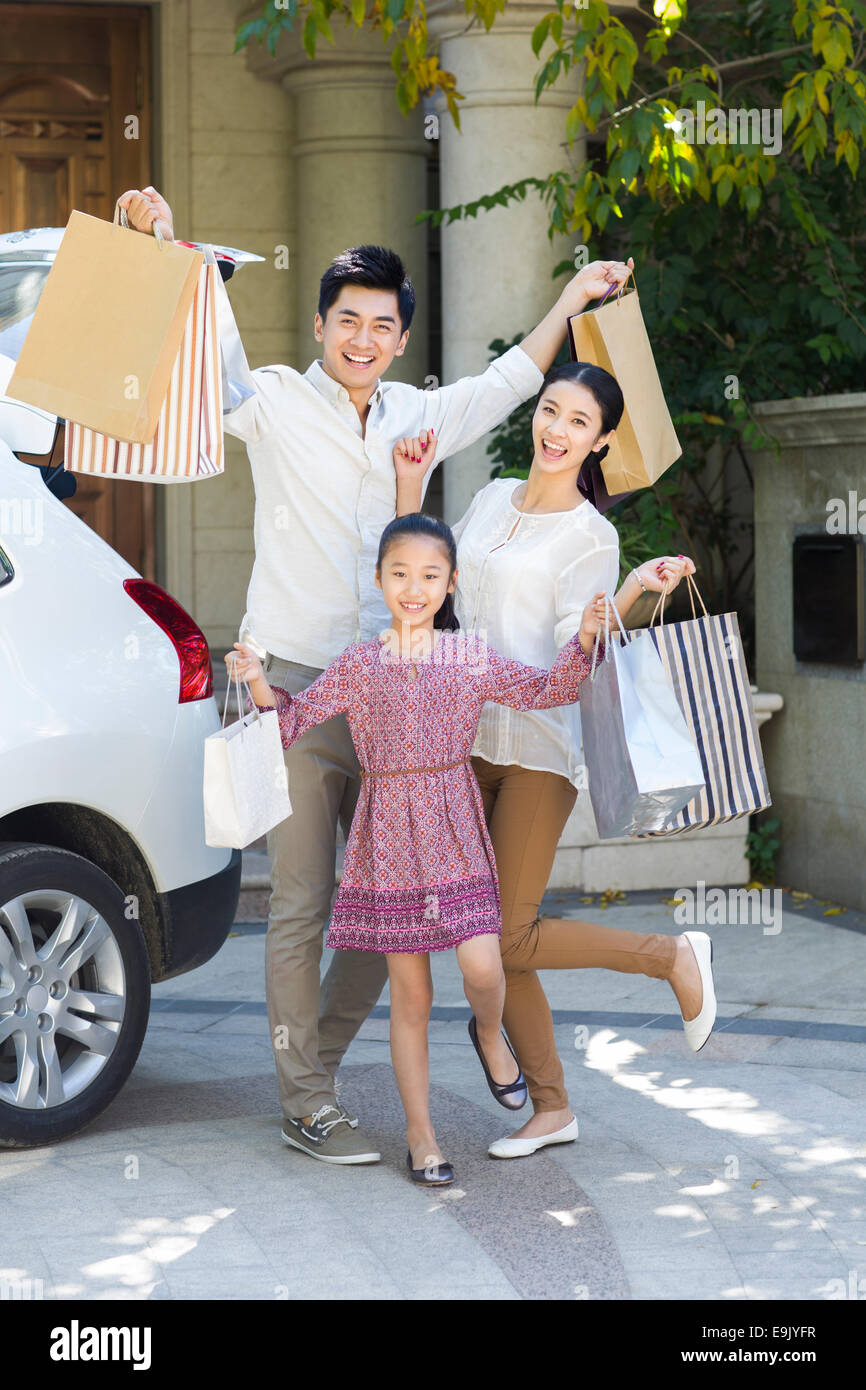 Young family coming back from shopping Stock Photo - Alamy