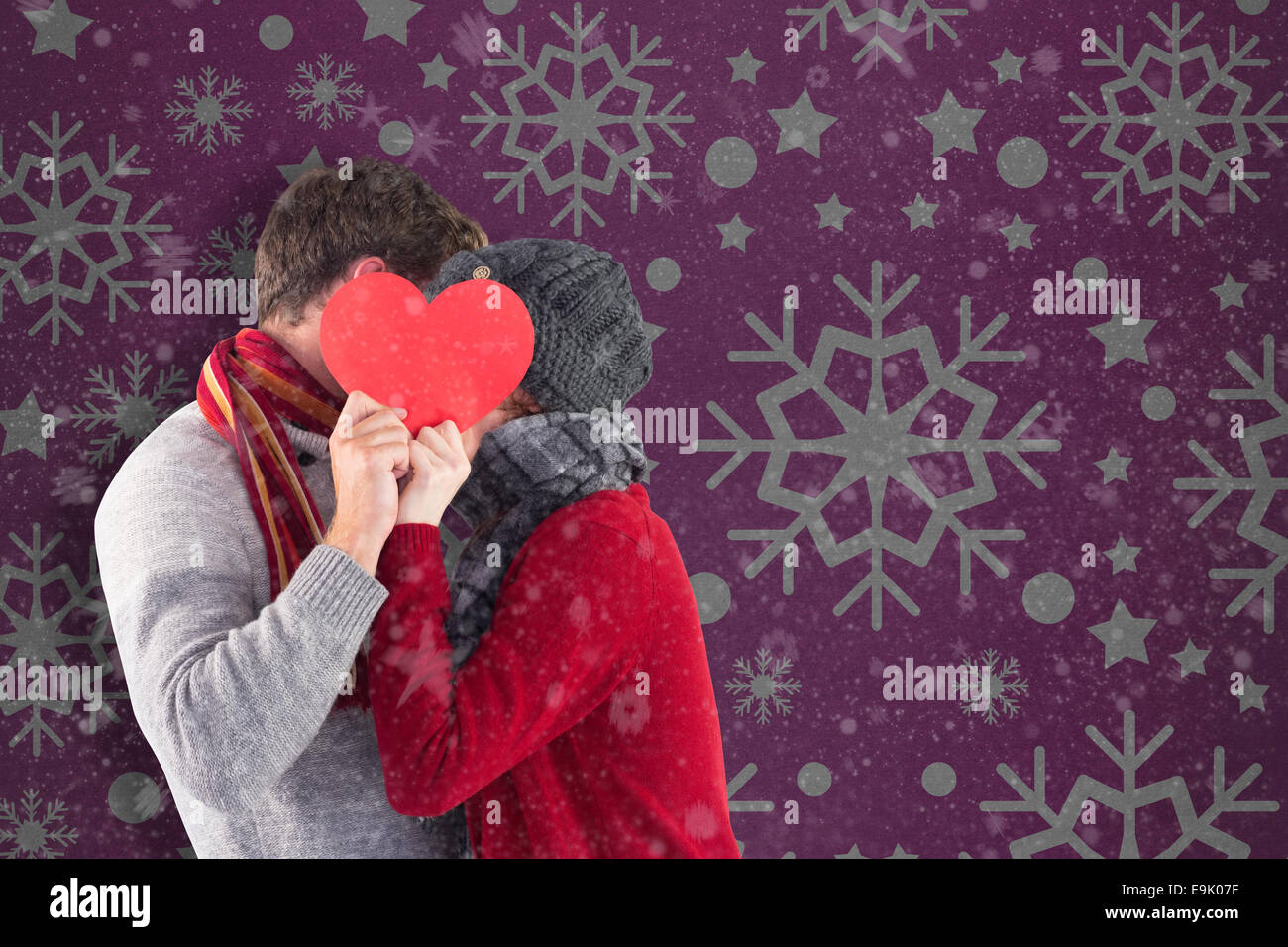 Couple holding a large heart in front of face Stock Photo - Alamy