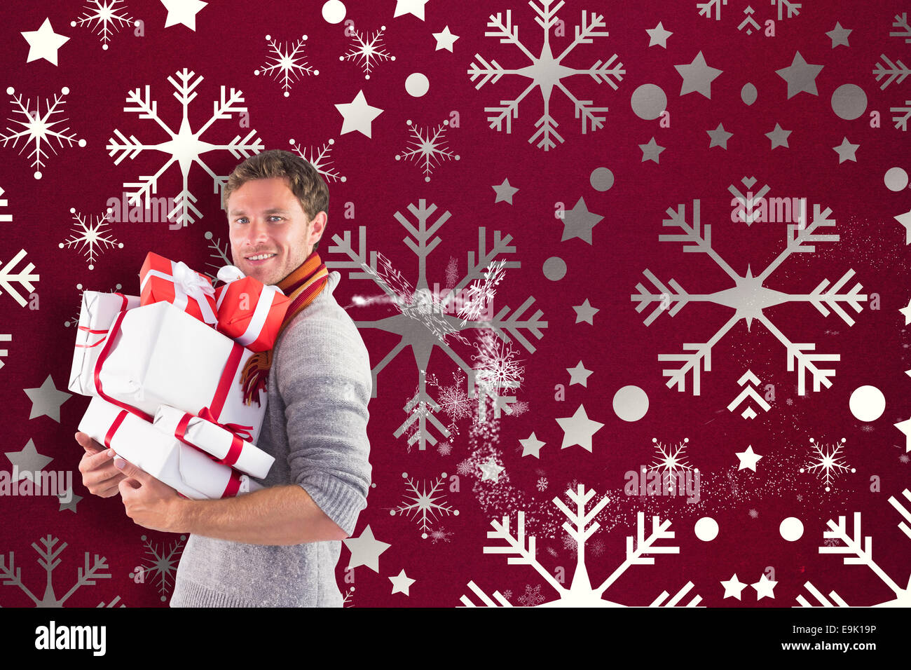Man holding some large presents Stock Photo - Alamy