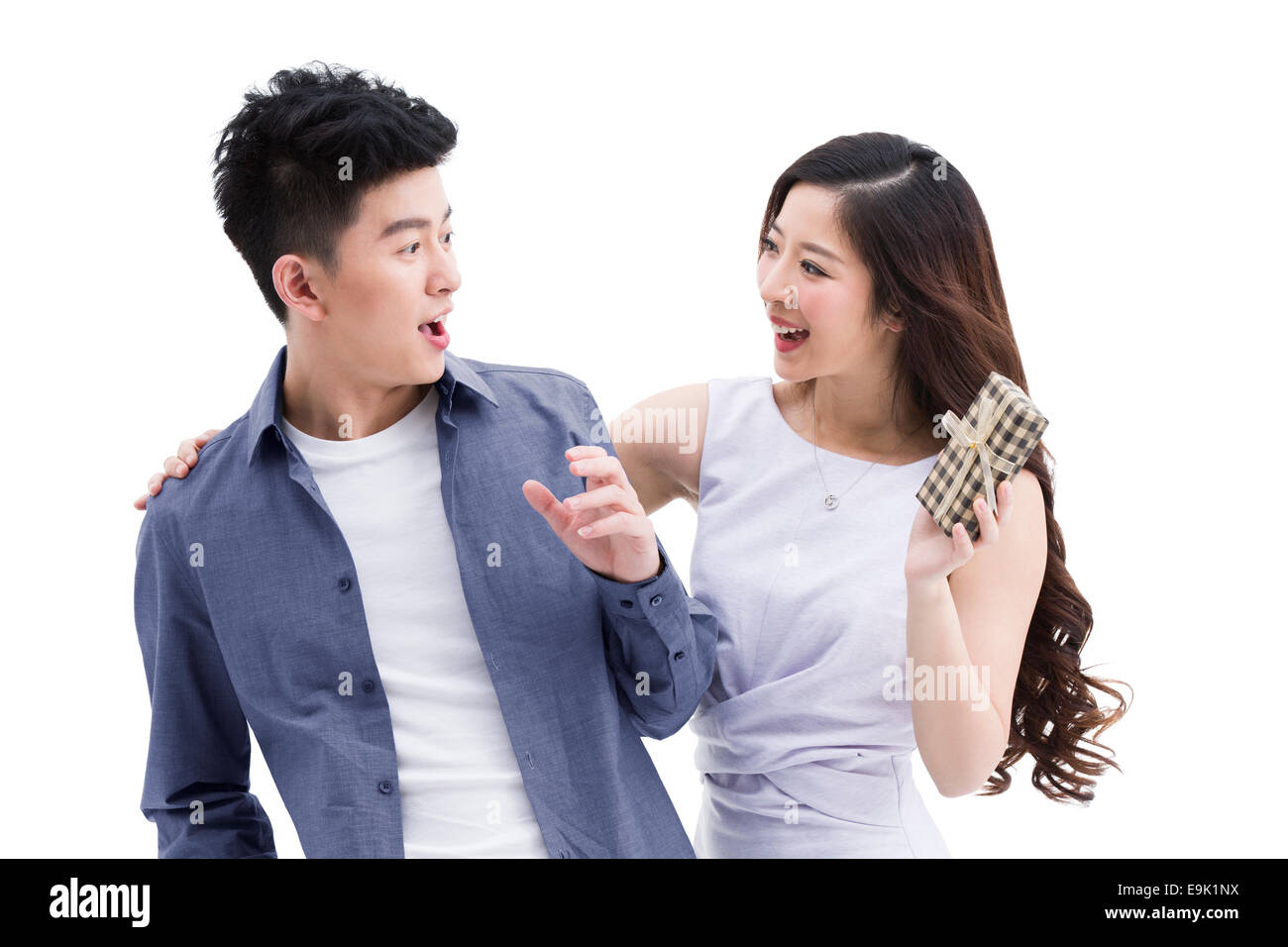 Young woman giving a gift to her boyfriend Stock Photo - Alamy