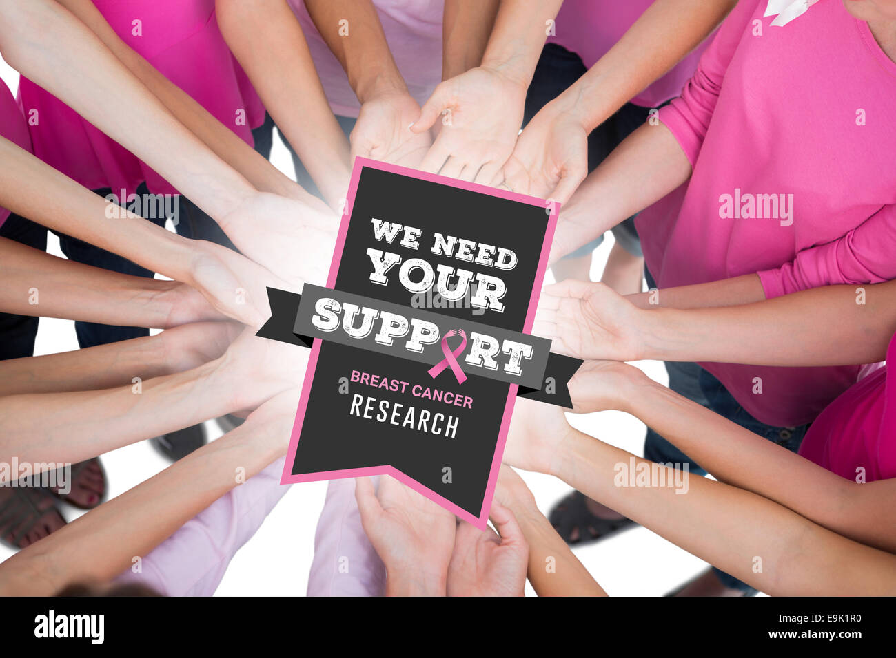Composite image of hands joined in circle holding breast cancer ...