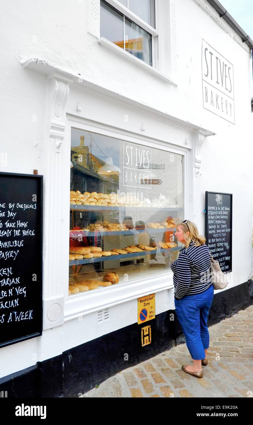 A potential customer looking at the window display of the St Ives ...