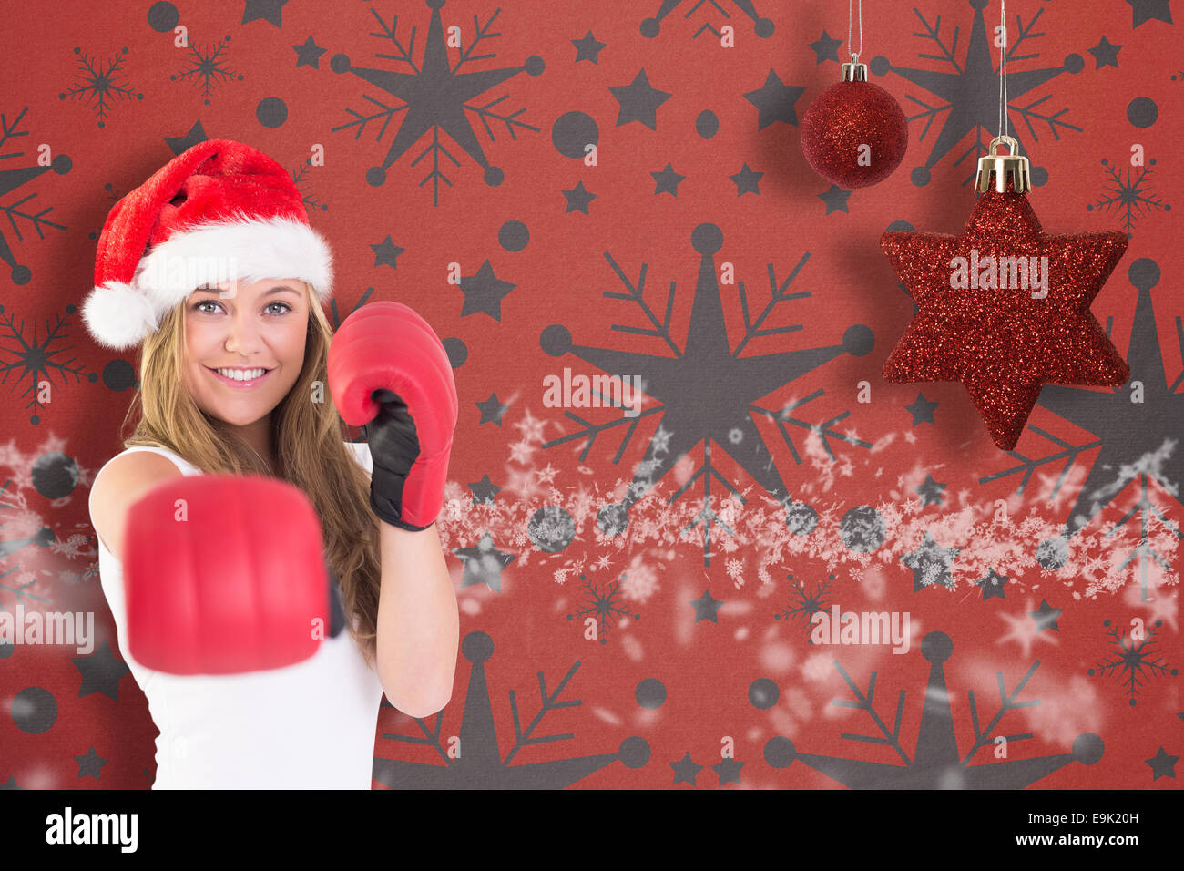 Festive blonde punching with boxing gloves Stock Photo - Alamy