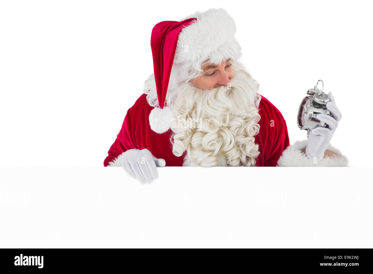 Happy santa holding alarm clock and sign Stock Photo - Alamy