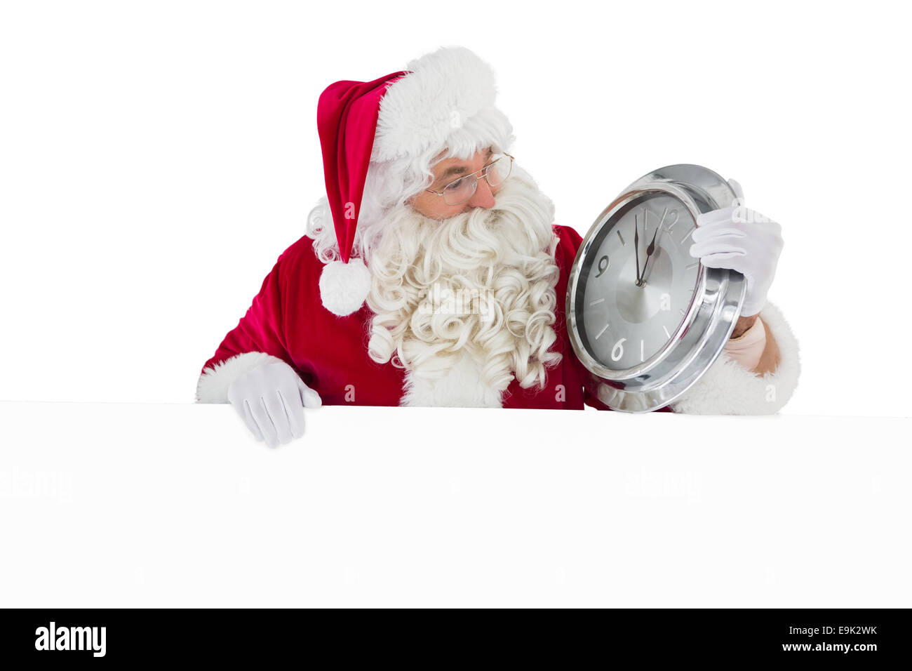 Santa holding a clock and sign Stock Photo - Alamy