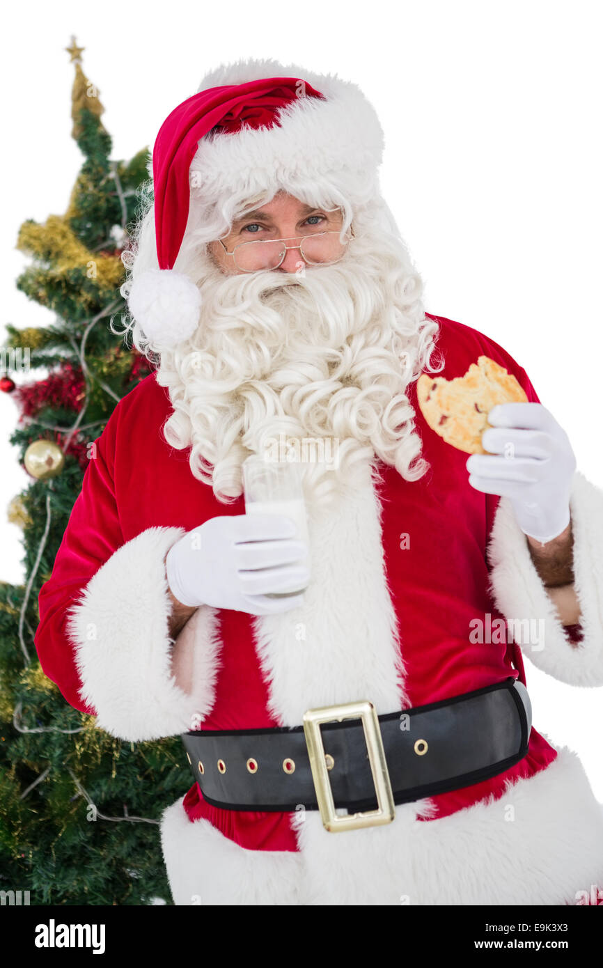 Cheerful santa eating a cookie Stock Photo - Alamy