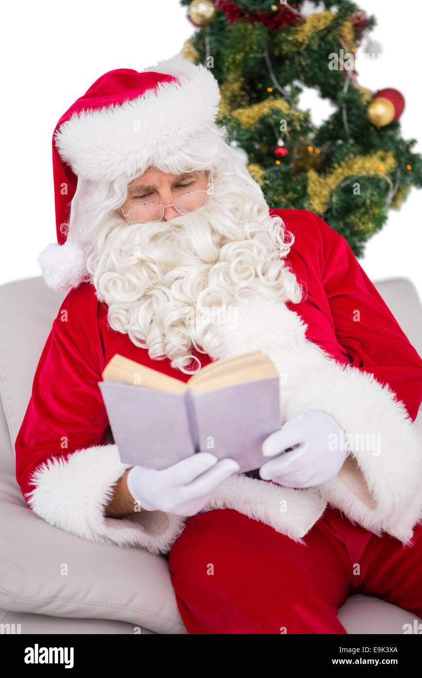 Relaxed santa reading on the couch Stock Photo - Alamy
