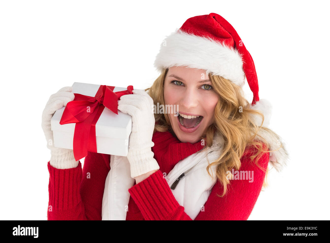 Pretty santa girl smiling at camera holding gift Stock Photo - Alamy