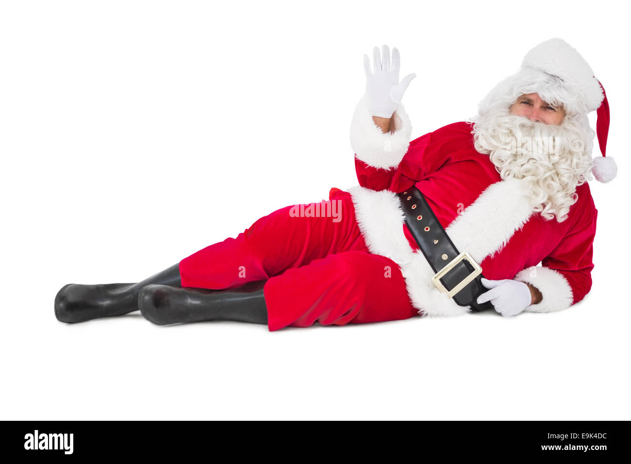Relaxed santa lying and waving Stock Photo - Alamy