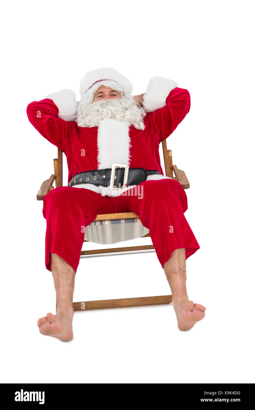 Happy santa relaxing on deckchair Stock Photo - Alamy
