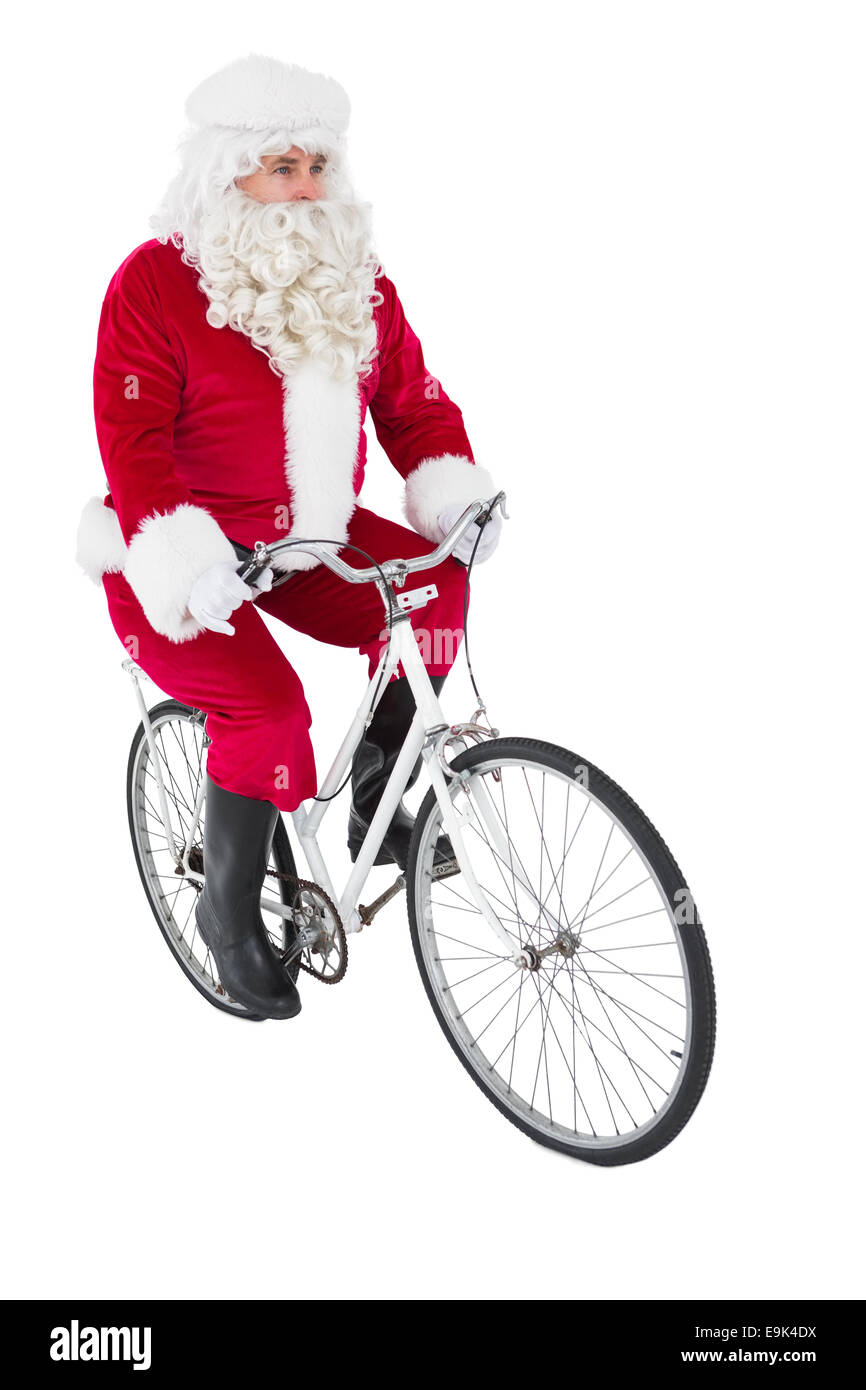 Cheerful father christmas cycling Stock Photo - Alamy