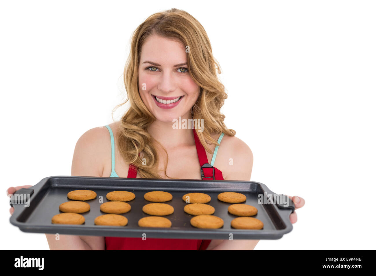 Smiling woman showing hot cookies Stock Photo - Alamy