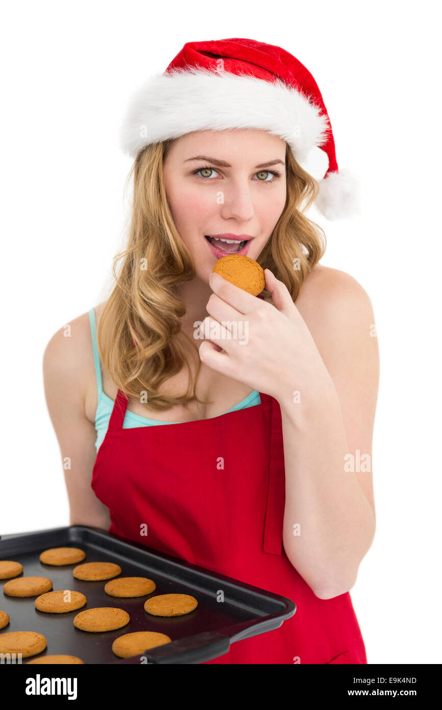 Festive blonde eating hot cookies Stock Photo - Alamy