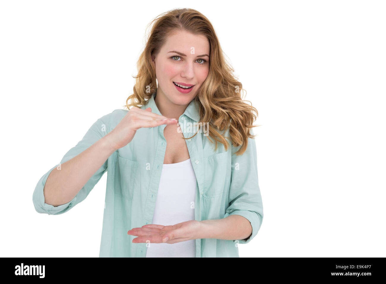 Pretty woman presenting something with her hand Stock Photo - Alamy