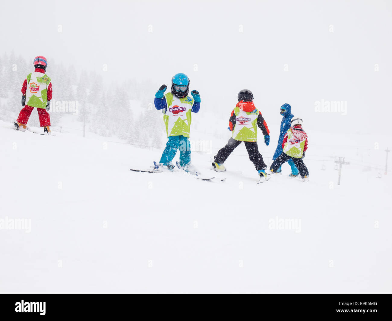 young children aged five years wearing helmets and goggles learning to ...