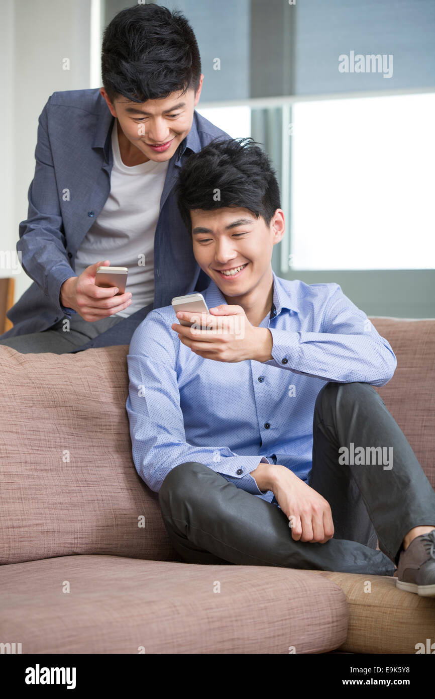 Young men with smart phones Stock Photo - Alamy