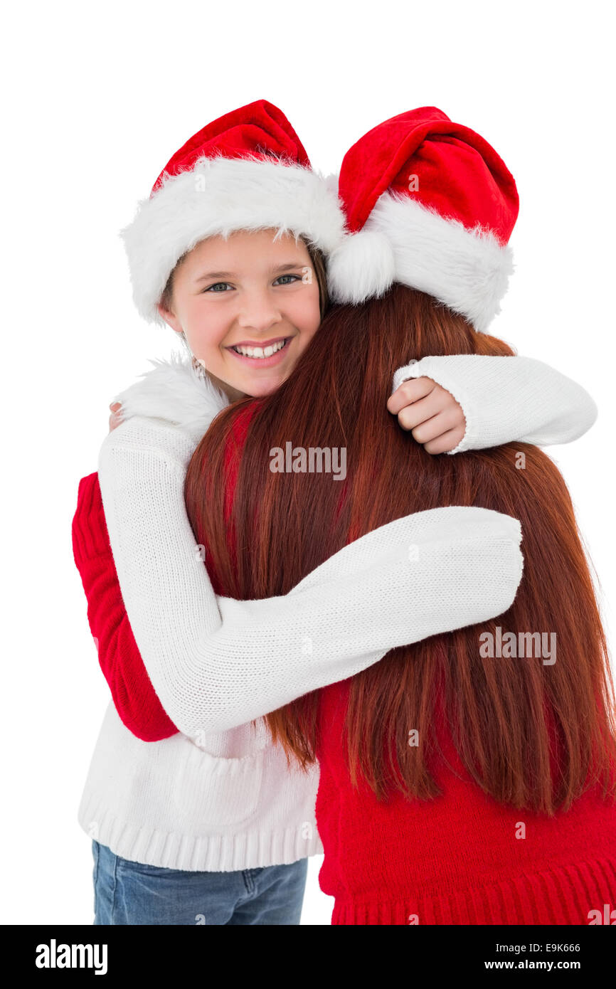 Festive mother giving daughter a hug Stock Photo - Alamy