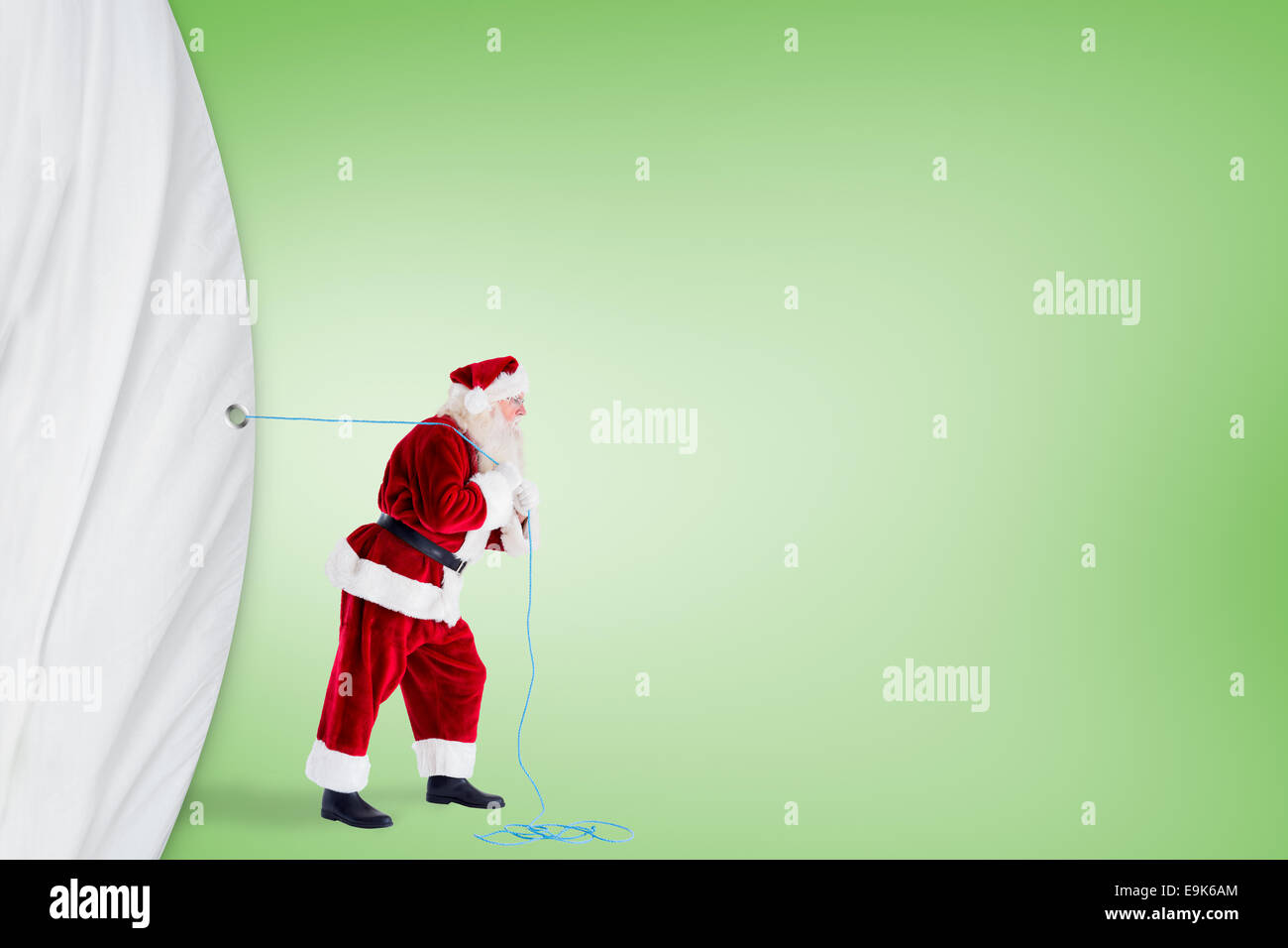 Santa claus pulling a rope Stock Photo - Alamy